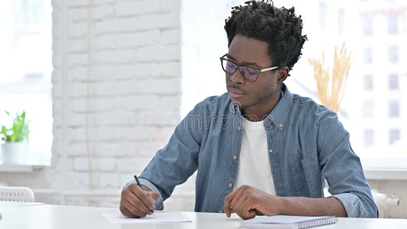 Young African Man Thinking and Writing Document Stock Footage - Video ...