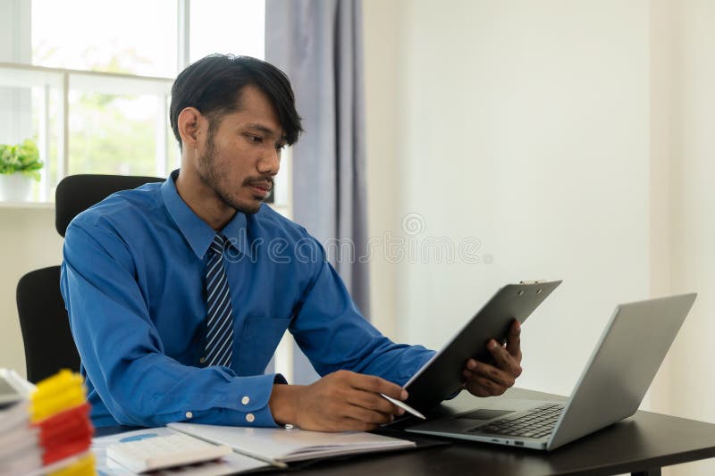 Young African Man Working with Analytics Sitting in Beautiful Workplace ...