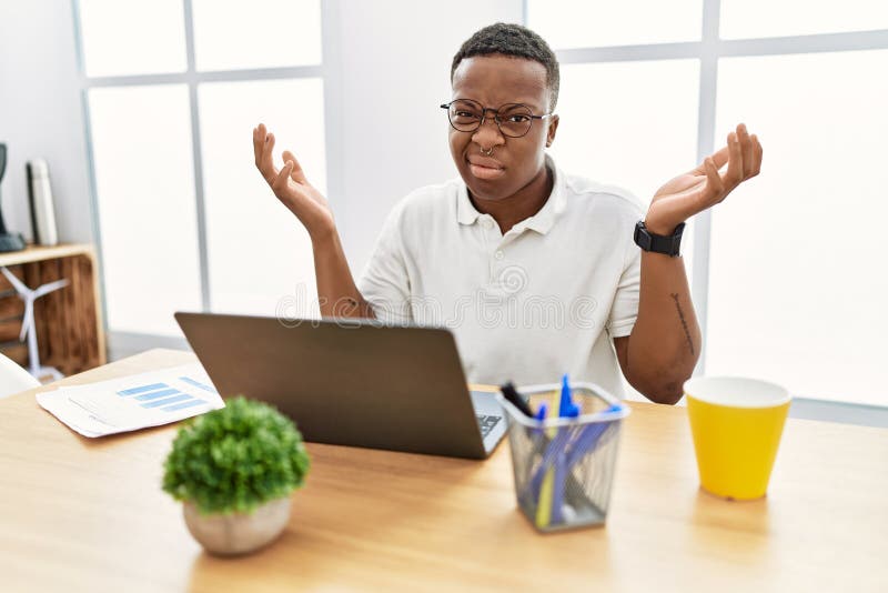 Young African Man Working at the Office Using Computer Laptop Clueless ...