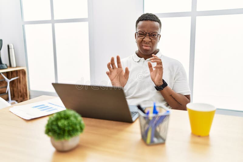 Young African Man Working at the Office Using Computer Laptop Disgusted ...