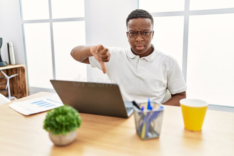 Young African Man Working at the Office Using Computer Laptop Looking ...