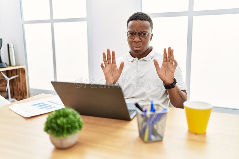 Young African Man Working at the Office Using Computer Laptop Moving ...
