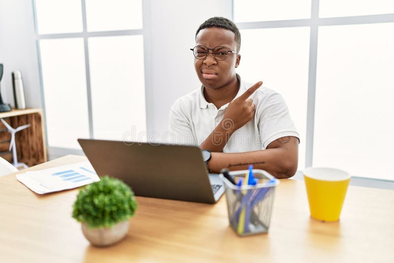 Young African Man Working at the Office Using Computer Laptop Pointing ...