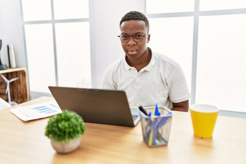 Young African Man Working at the Office Using Computer Laptop Relaxed ...