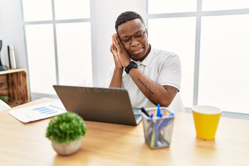 Young African Man Working at the Office Using Computer Laptop Sleeping ...