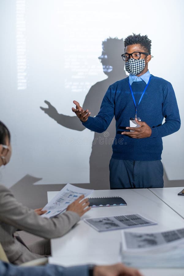 Young African Programmer in Protective Mask Standing by Interactive ...