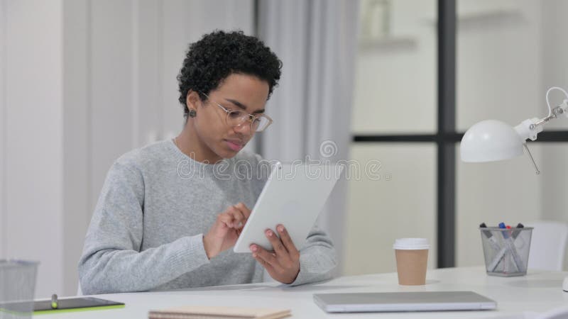 African Woman Using Tablet at Work Stock Photo - Image of surfing ...