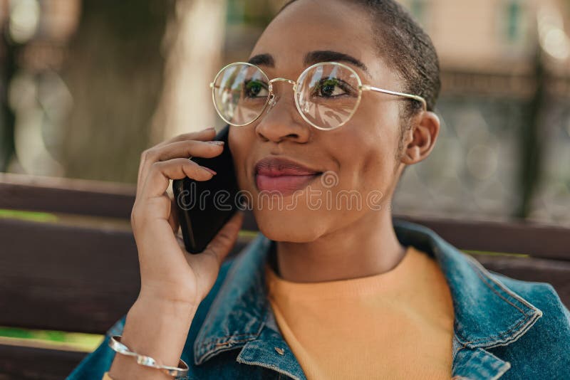 Young Afro American Woman Talking At Modern Smartphone Stock Image