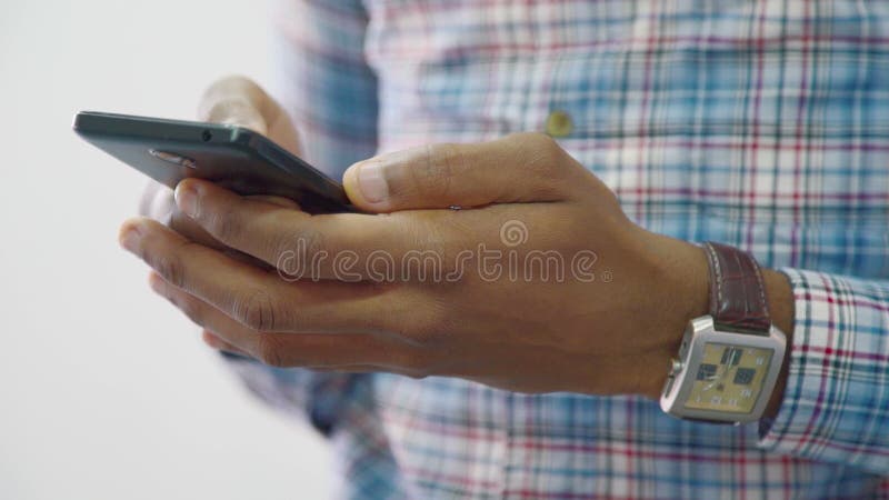 Young Afroamerican Man is Holding Smartphone in Hand, Standing in Light ...