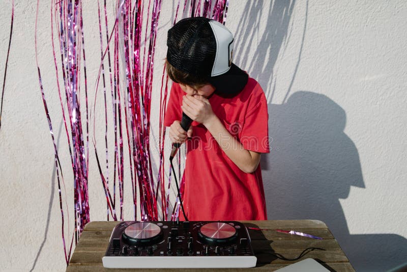 Young American Boy Wearing Headphones Near the Purple Confetti Tapes ...