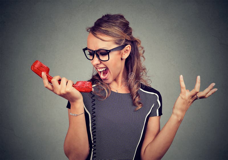 Young Angry Woman Yelling into Red Phone Stock Image - Image of cell ...