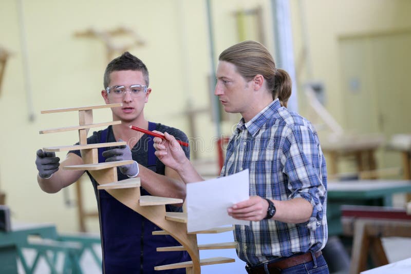 Young Apprentice with Carpentry Instructor Working on Wood Stock Image ...
