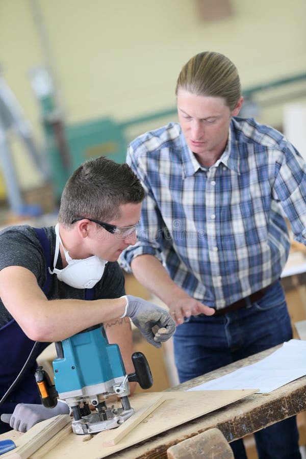 Young Apprentice in Carpentry School with Instructor Stock Photo ...