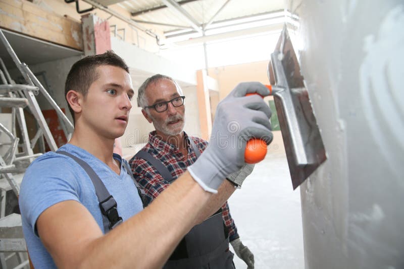 Young Apprentice with Experienced Plasterer Stock Photo - Image of ...