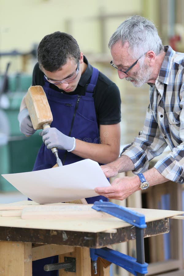 Young Apprentice with Instructor Working on Wood Stock Photo - Image of ...
