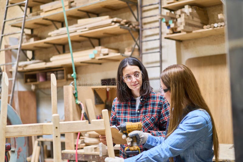 Young Apprentice Learning from Experienced Mentor in a Lumberyard Stock ...