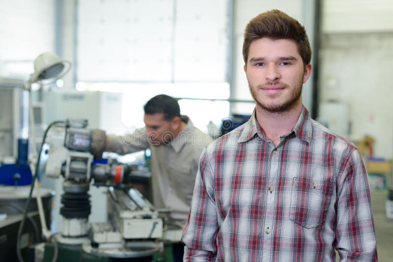 Young Apprentice Looking at Camera Stock Photo - Image of woodwork ...