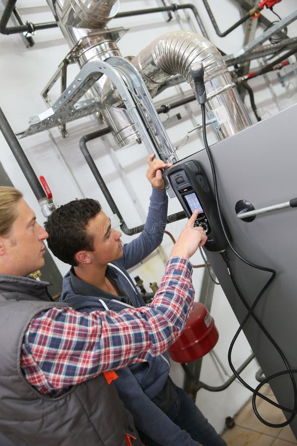 Young Men in Professional Training Controlling Heat Pump Stock Photo ...