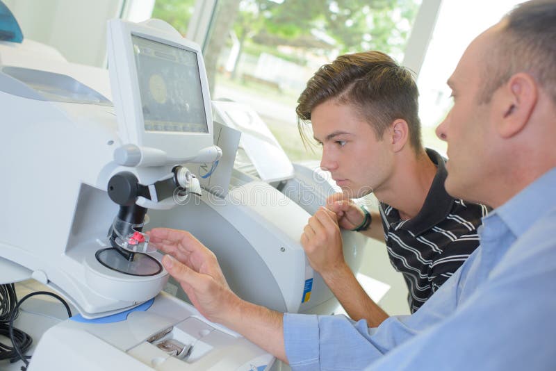 Young Apprentice and Optician with Optical Instruments Stock Image ...