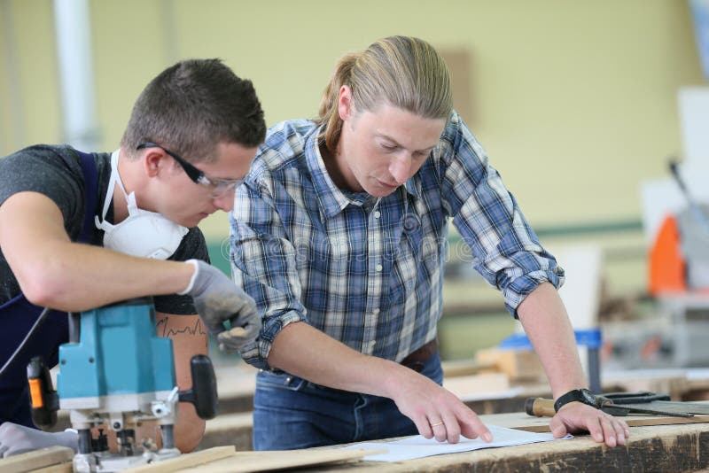 Young Apprentice with Professional Carpenter Learning Stock Image ...