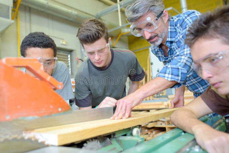 Young Apprentices Using Electric Saw Stock Image - Image of mentor ...
