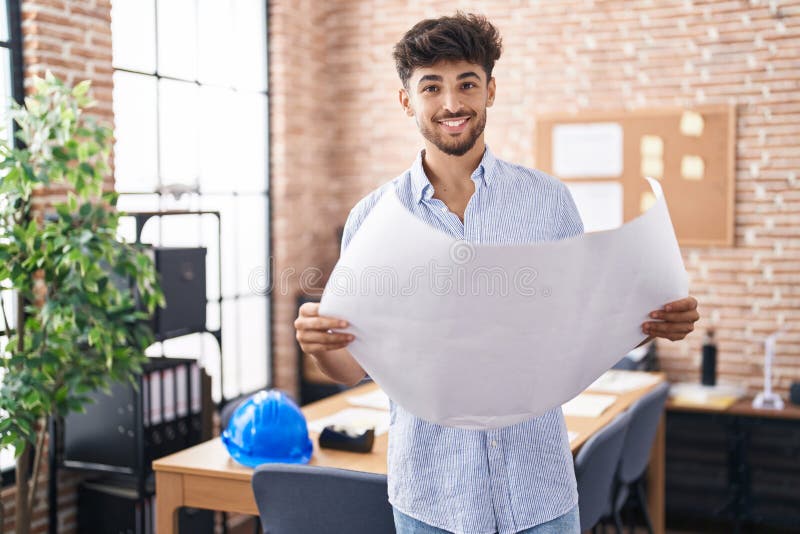 Young Arab Man Architect Reading Blueprints at Office Stock Image ...