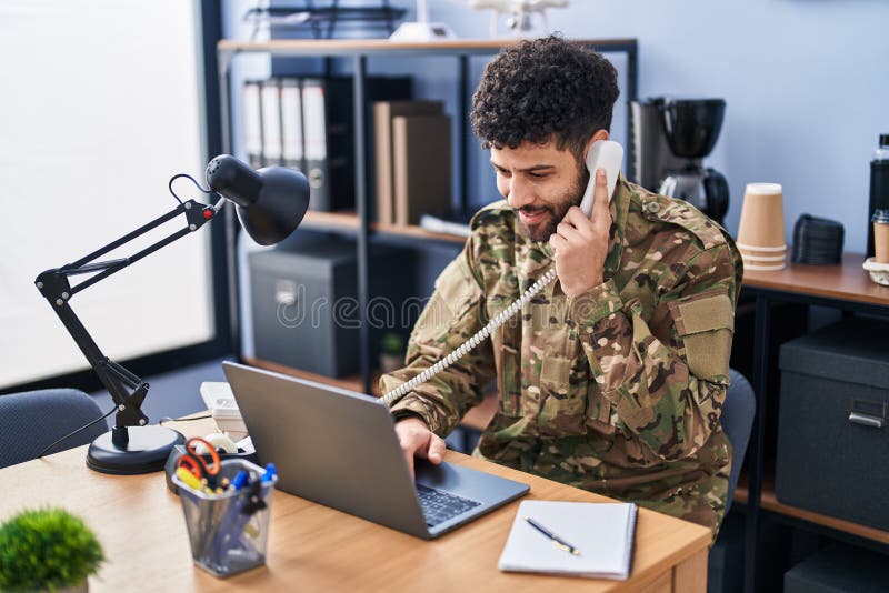 Young Arab Man Army Soldier Using Laptop Talking on the Telephone at ...