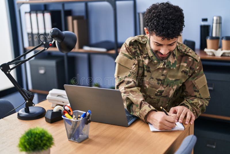 Young Arab Man Army Soldier Using Laptop Writing on Notebook at Office ...