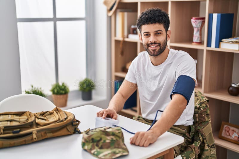 Young Arab Man Army Soldier Using Tensiometer at Home Stock Photo ...