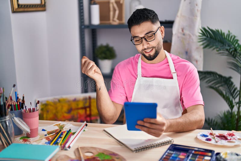 Young Arab Man Artist Drawing on Notebook Having Video Call at Art ...
