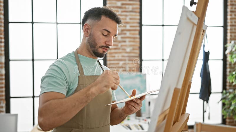 Young Arab Man Artist Drawing with Serious Face at Art Studio Stock ...
