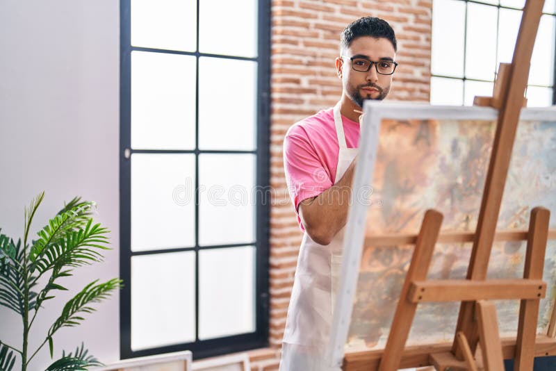 Young Arab Man Artist Looking Draw with Doubt Expression at Art Studio ...