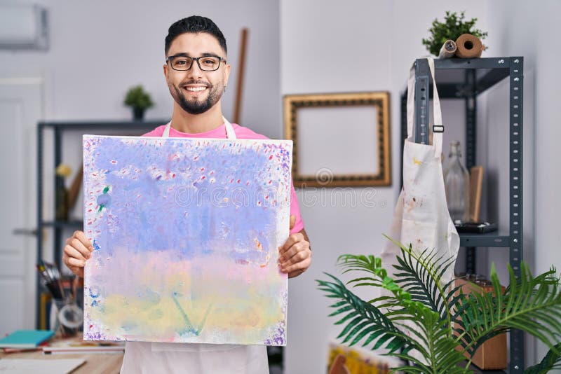 Young Arab Man Artist Smiling Confident Holding Draw at Art Studio ...