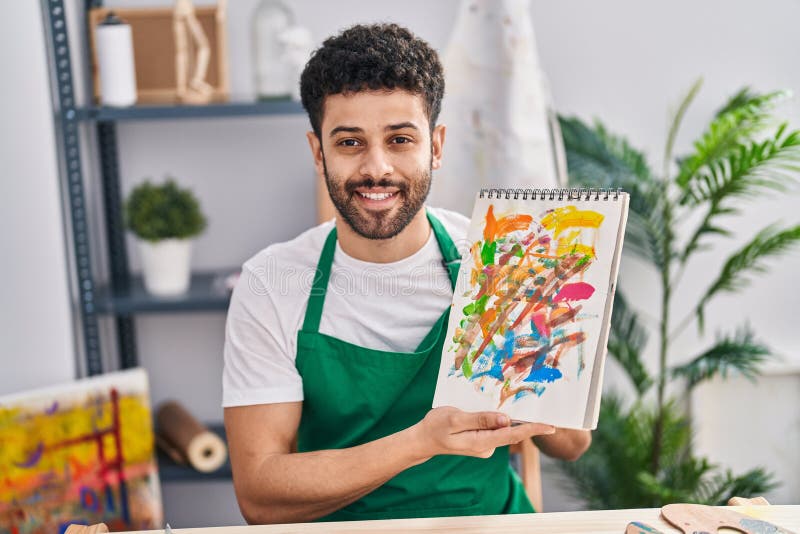 Young Arab Man Artist Smiling Confident Holding Draw at Art Studio ...