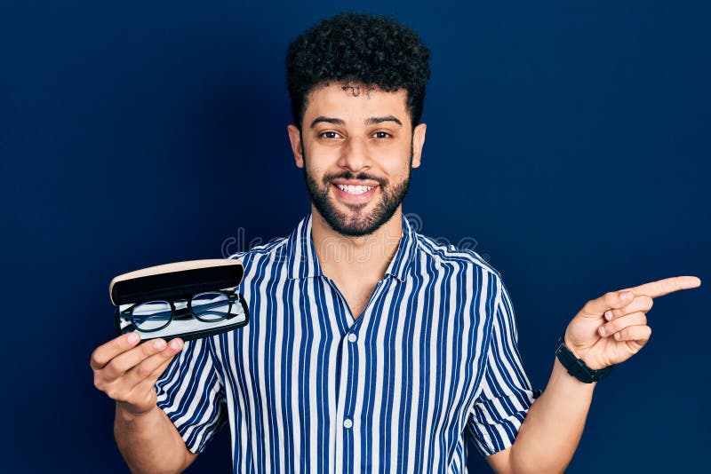 Young Arab Man With Beard Holding Glasses In Eyewear Case Smiling Happy