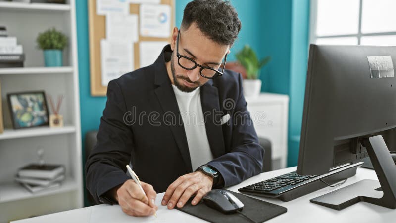 Young Arab Man Business Worker Using Computer Taking Notes at the ...