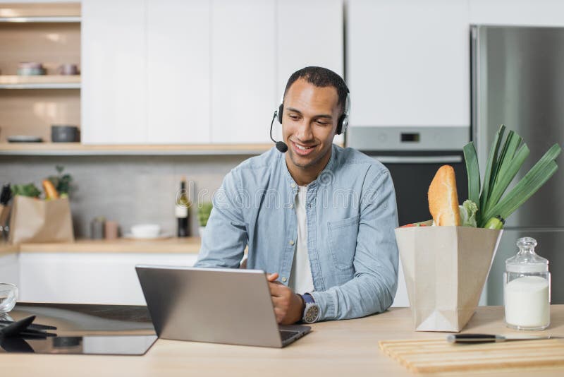 Young Arab Man, Chef Sitting in Well-equipped Modern Kitchen Having ...