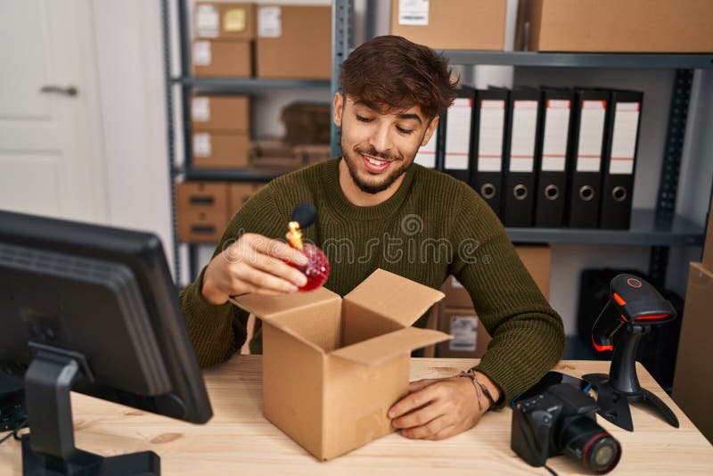 Young Arab Man Ecommerce Business Worker Packing Perfume at Office ...