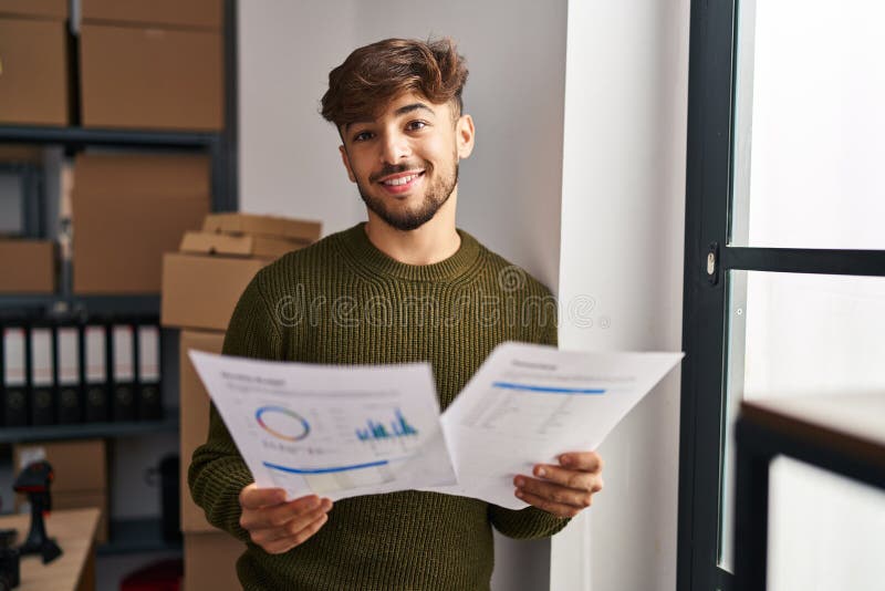 Young Arab Man Ecommerce Business Worker Reading Document at Office ... Young Arab Man Ecommerce Business Worker Reading Document at Office ...