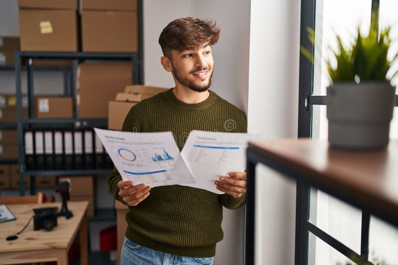 Young Arab Man Ecommerce Business Worker Reading Document at Office ... Young Arab Man Ecommerce Business Worker Reading Document at Office ...