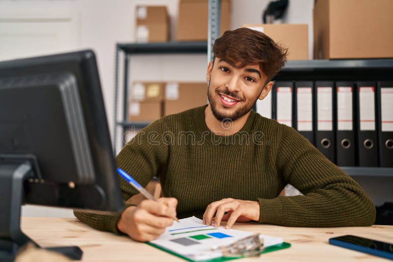 Young Arab Man Ecommerce Business Worker Writing on Document Using ...
