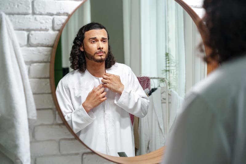 Young Arab Man Getting Ready and Looking at the Mirror in the Bathroom ...