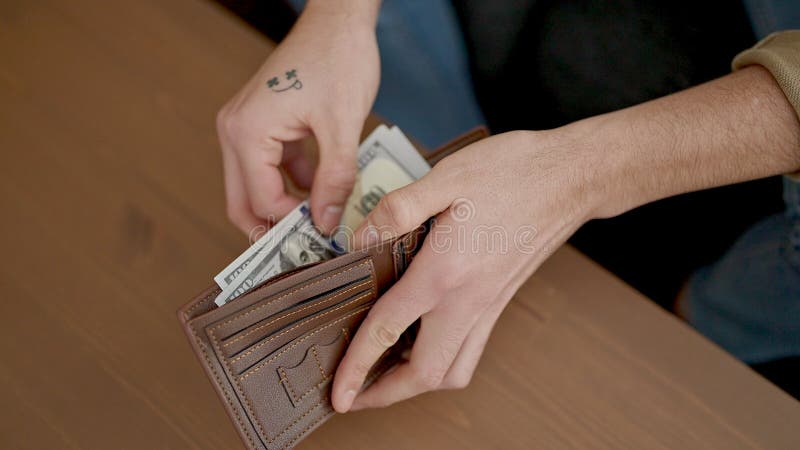 Young Arab Man Holding Dollars on Wallet Sitting on Sofa at Home Stock ...