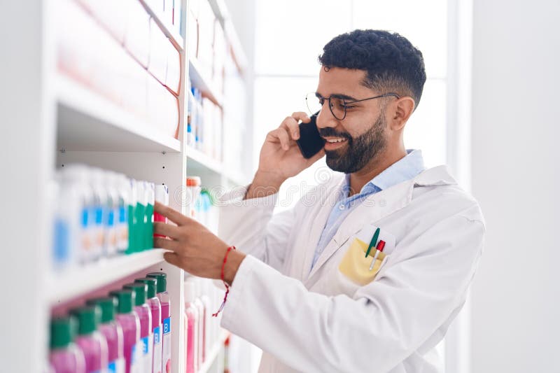 Young Arab Man Pharmacist Holding Toothpaste Bottle Talking on ...