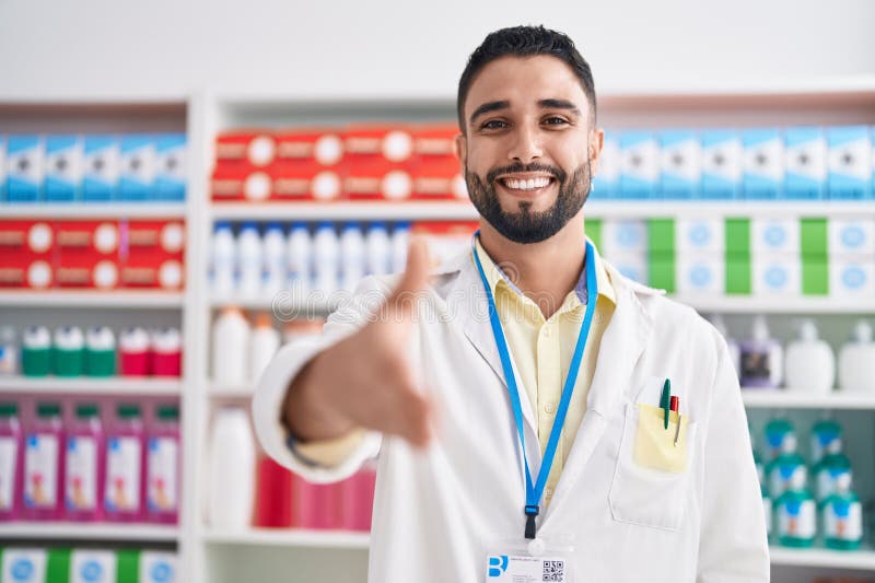 Young Arab Man Pharmacist Smiling Confident Shake Hand at Pharmacy ...