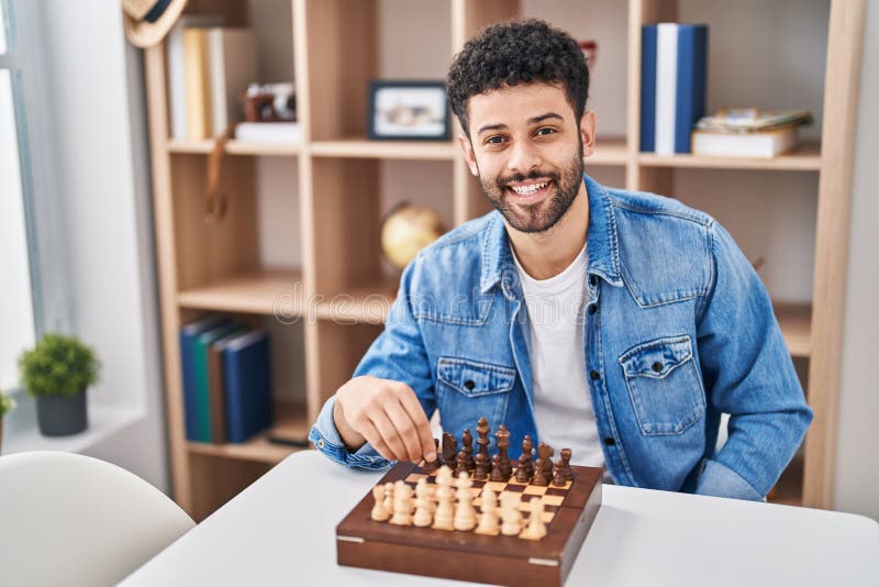 Young Arab Man Playing Chess Sitting on Table at Home Stock Photo ...