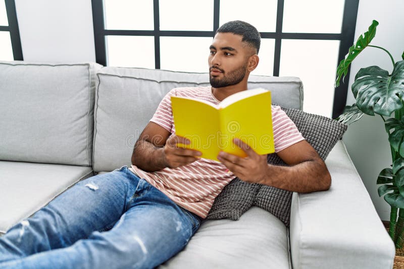 Young Arab Man Reading Book at Home Stock Photo - Image of smart ...