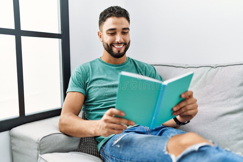 Young Arab Man Reading Book Lying on Sofa at Home Stock Photo - Image ... Young Arab Man Reading Book Lying on Sofa at Home Stock Photo - Image ...
