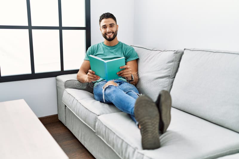 Young Arab Man Reading Book Lying on Sofa at Home Stock Photo - Image ... Young Arab Man Reading Book Lying on Sofa at Home Stock Photo - Image ...