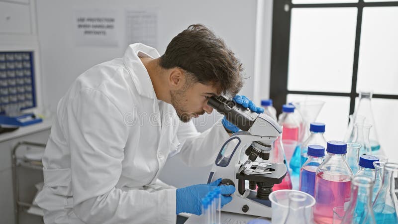 Young Arab Man Scientist Using Microscope at Laboratory Stock Image ...